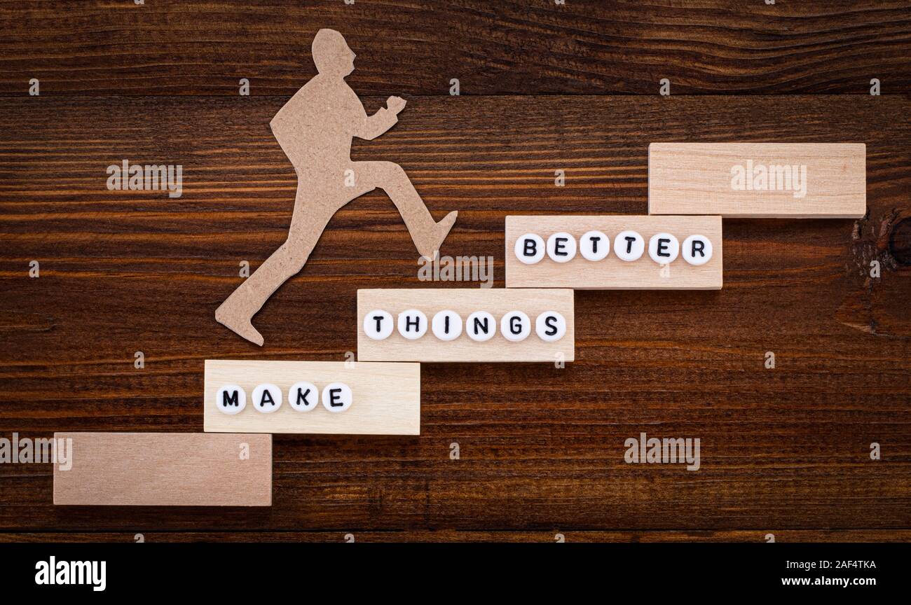 Make things better - Improvement Concept. Paper man climbing the steps ...