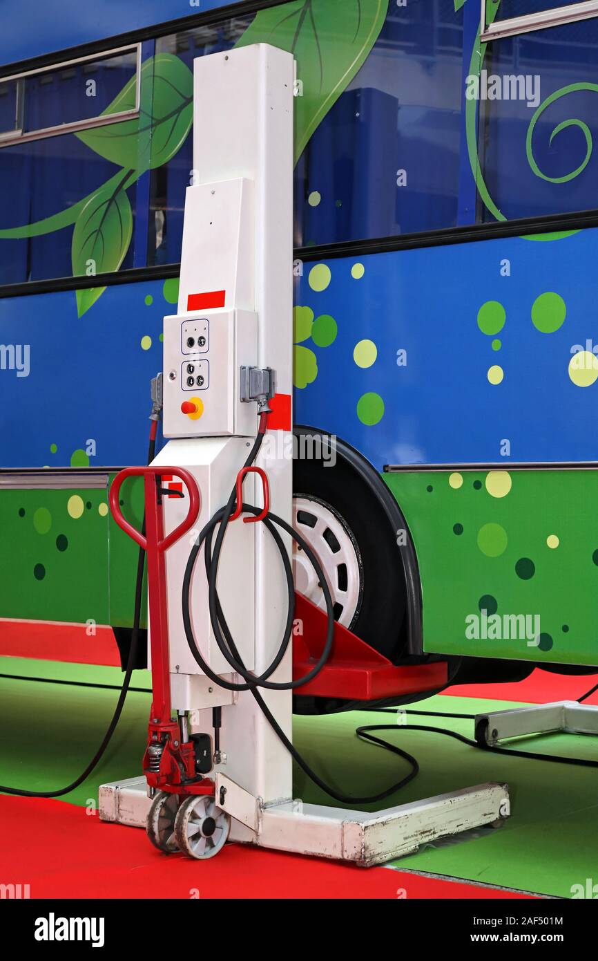 Bus at elevated platform in garage service Stock Photo - Alamy