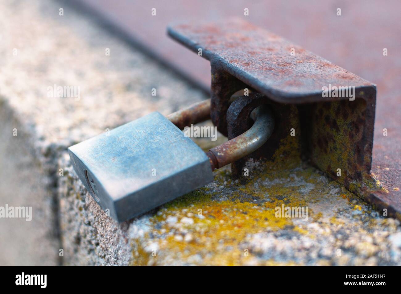 a simple lock closing the lid of the rusty hatch Stock Photo - Alamy