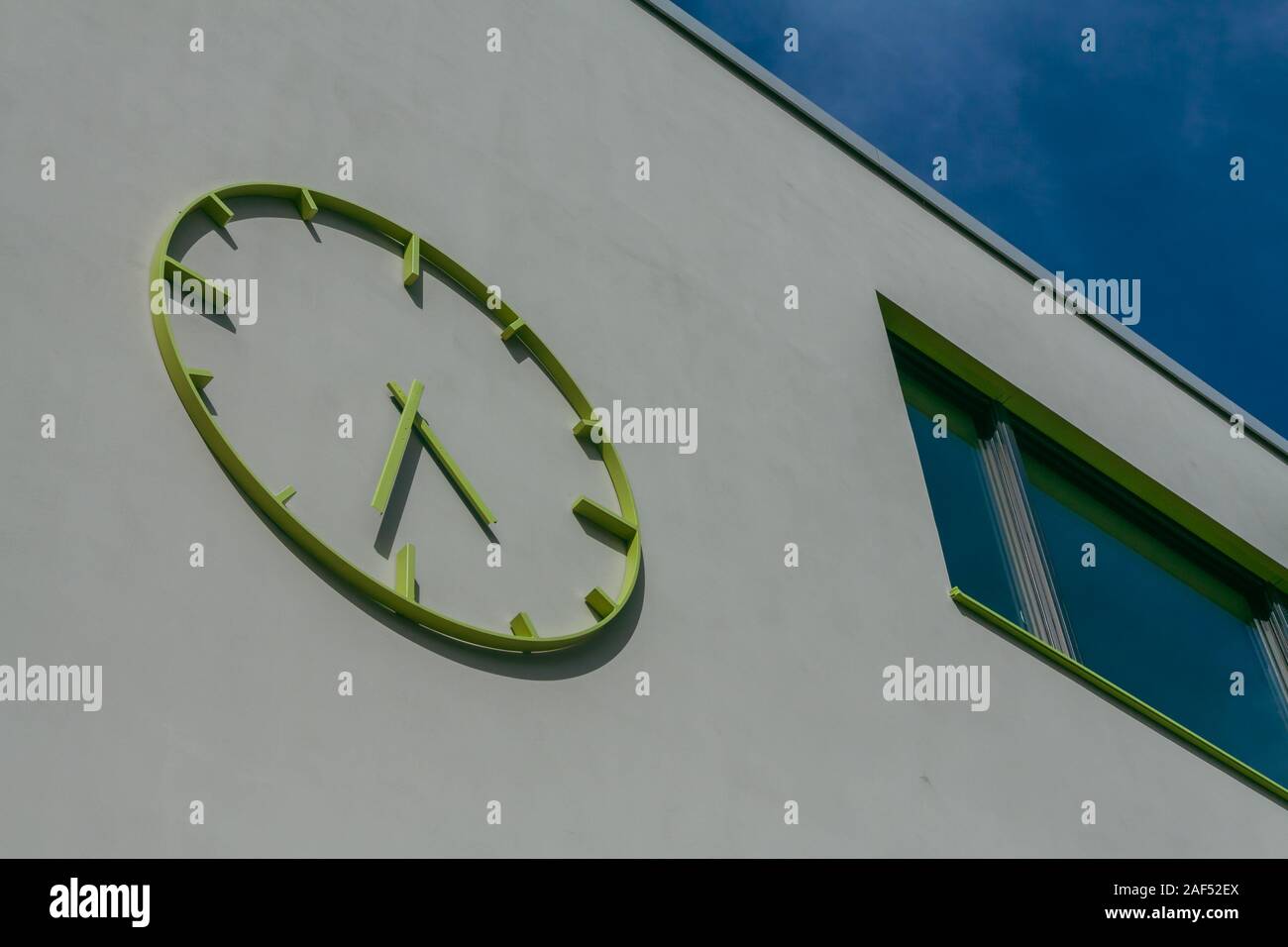 A modern building with a modern clock Stock Photo - Alamy