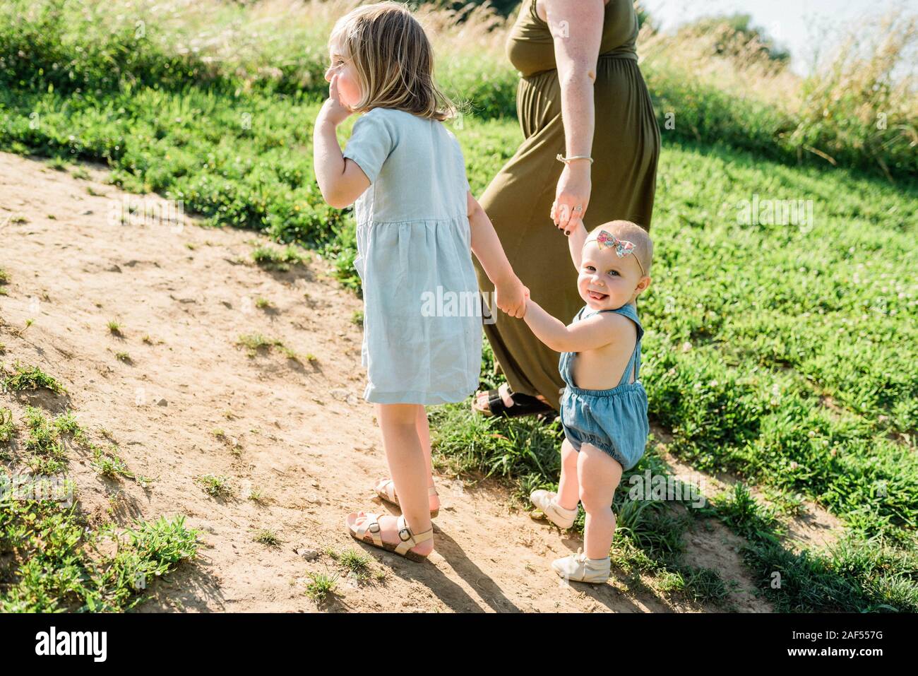 Two Sisters Hugging Tree High Resolution Stock Photography and Images ...