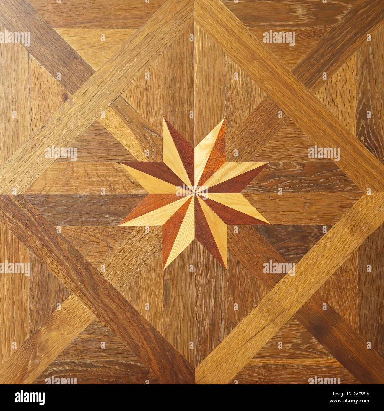 Decorative star at hard wood parquet floor Stock Photo - Alamy