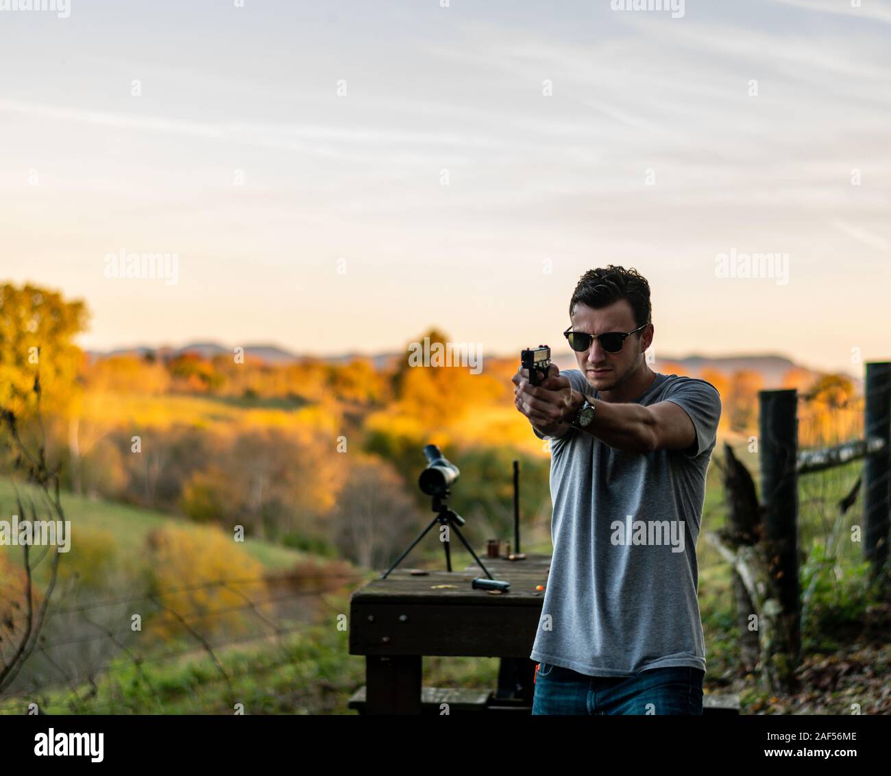 young caucasian man holding pistol/handgun at outdoor range in Kentucky ...