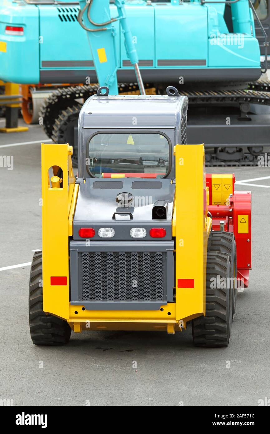 Skid steer front loader machine at construction site Stock Photo - Alamy
