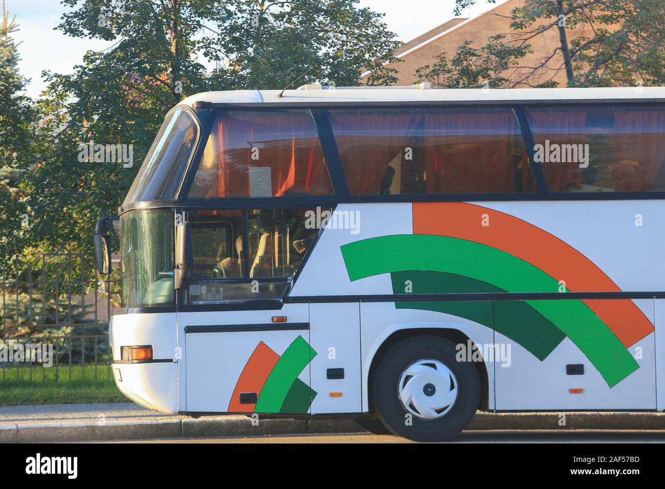 tourist bus traveling on city street closeup Stock Photo - Alamy