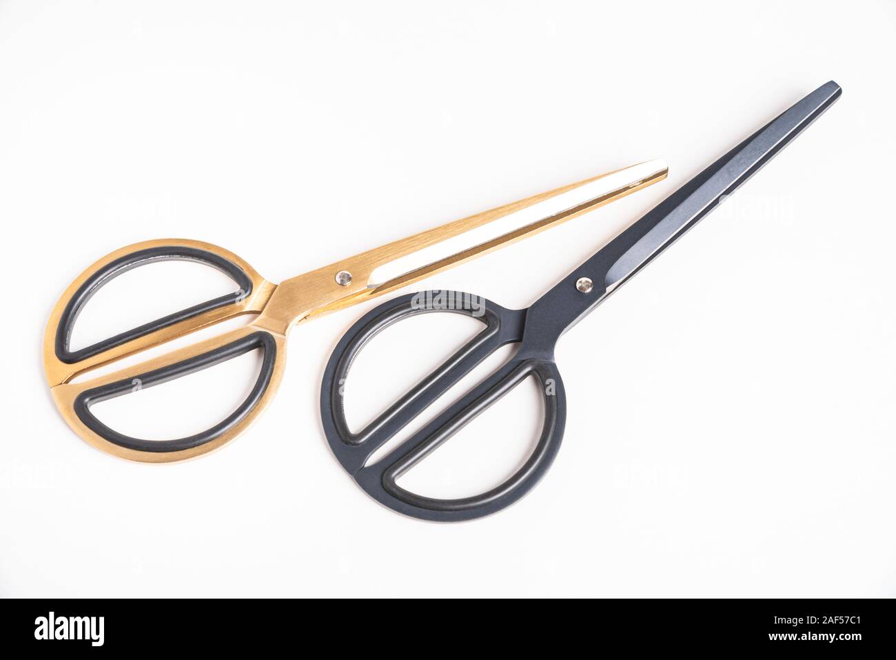 Two pairs of retro or vintage style scissors in black and gold set on a ...