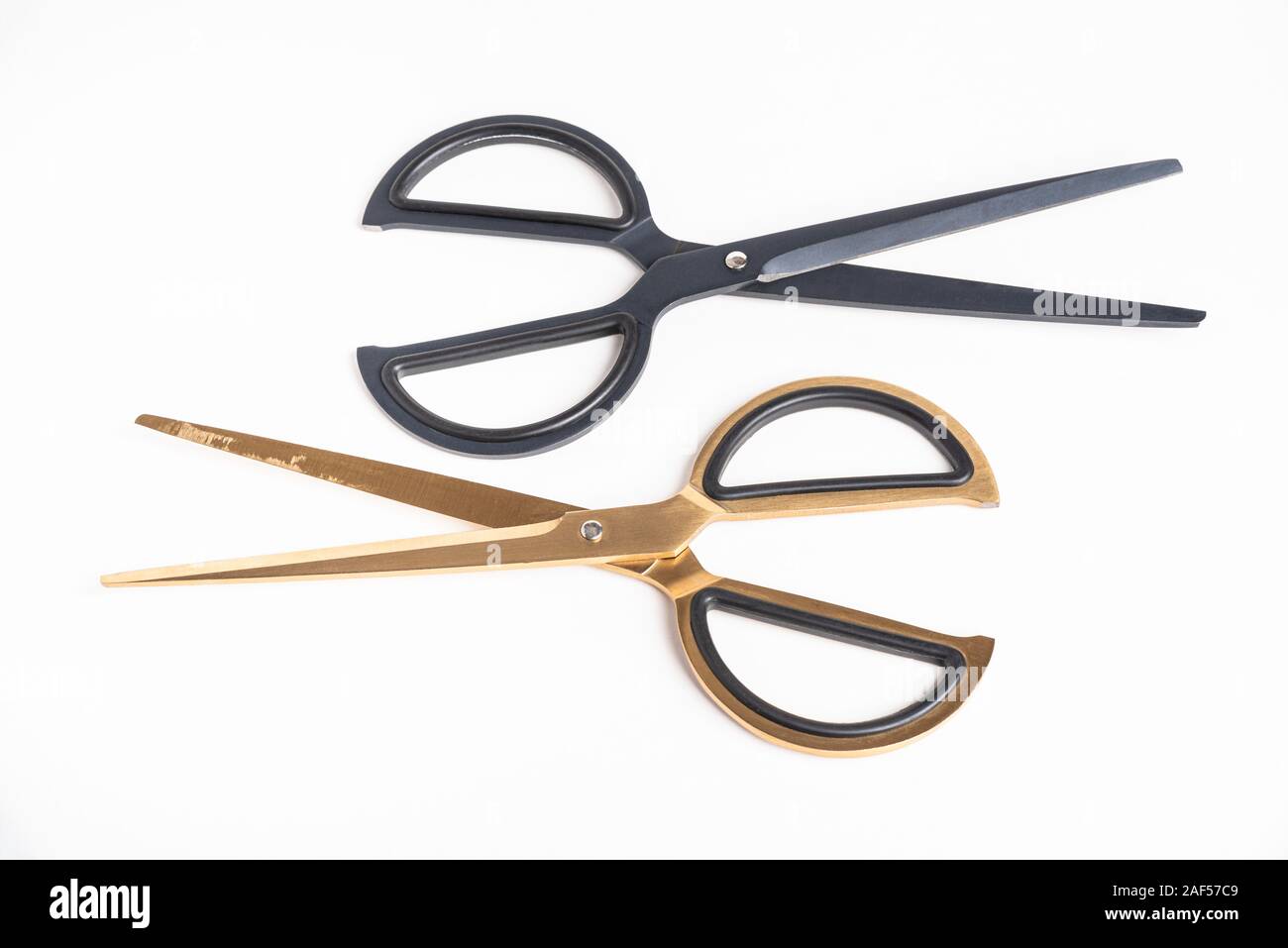 Two pairs of retro or vintage style scissors in black and gold set on a ...