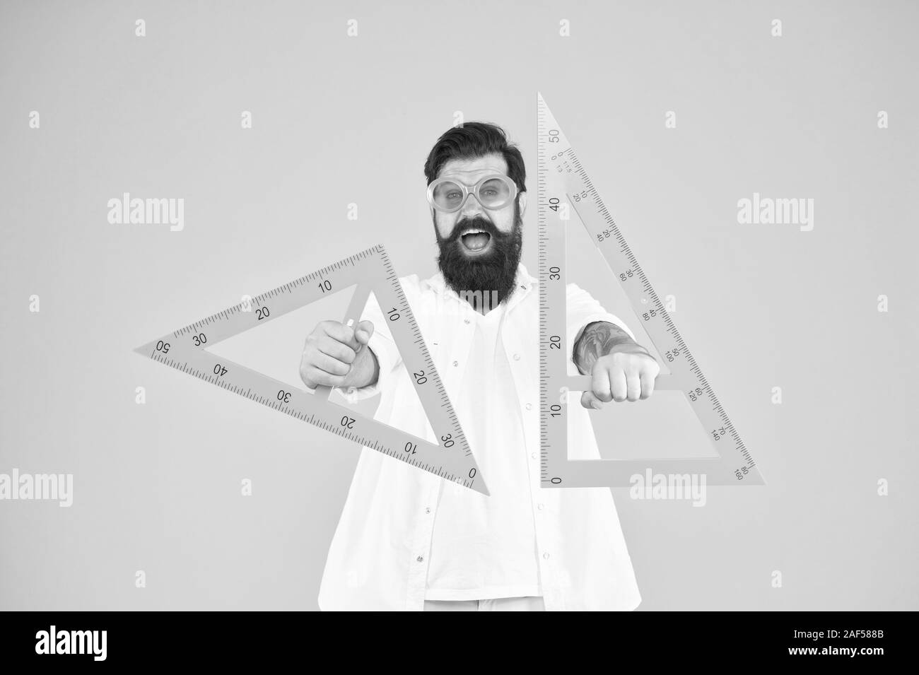 Leading engineer of the project. Smart engineer holding triangles on ...