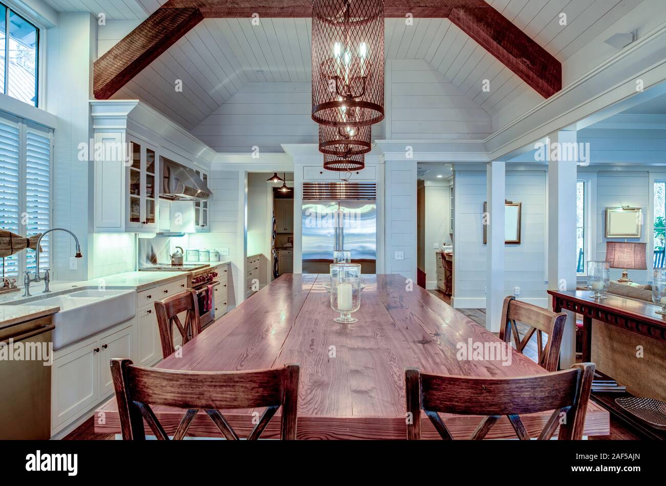 Large luxury kitchen with wood table and high end appliances Stock ...