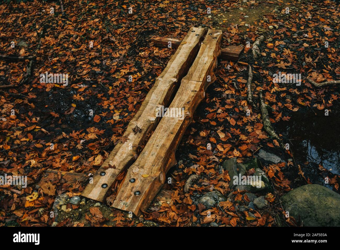 A Man Made Log Bridge Crossing a Small Stream Stock Photo - Alamy