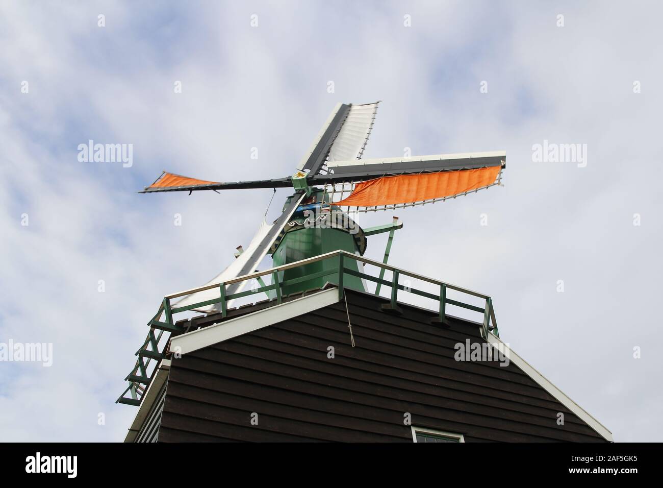 Traditional Dutch windmill with the cloudy sky in spring at the Zaanse ...