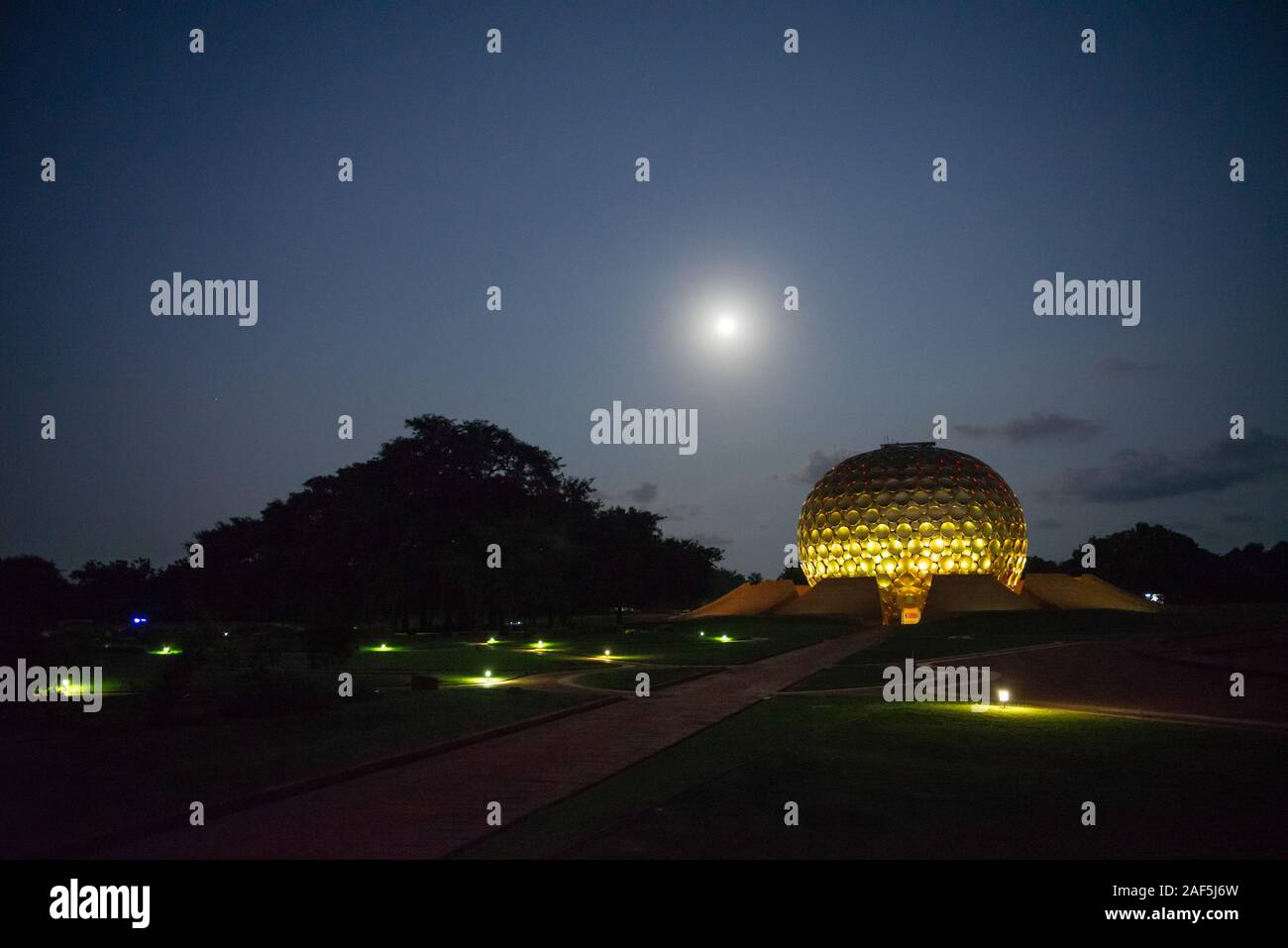 AUROVILLE, INDIA - December 2019: The Matrimandir and the banyan tree ...
