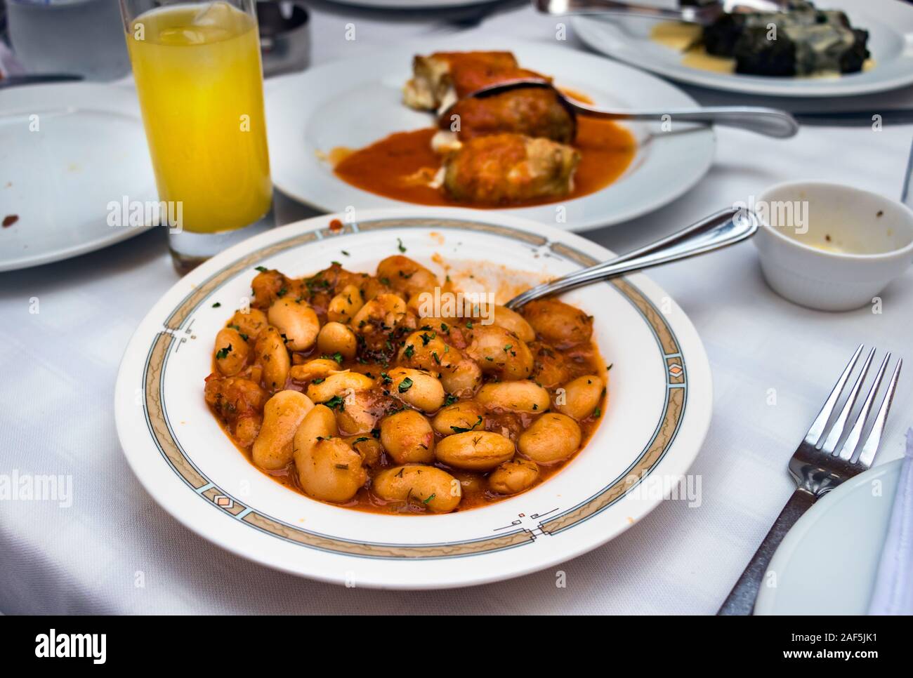 A traditional greek dish Fasolia - Giant beans on a tavern table ...