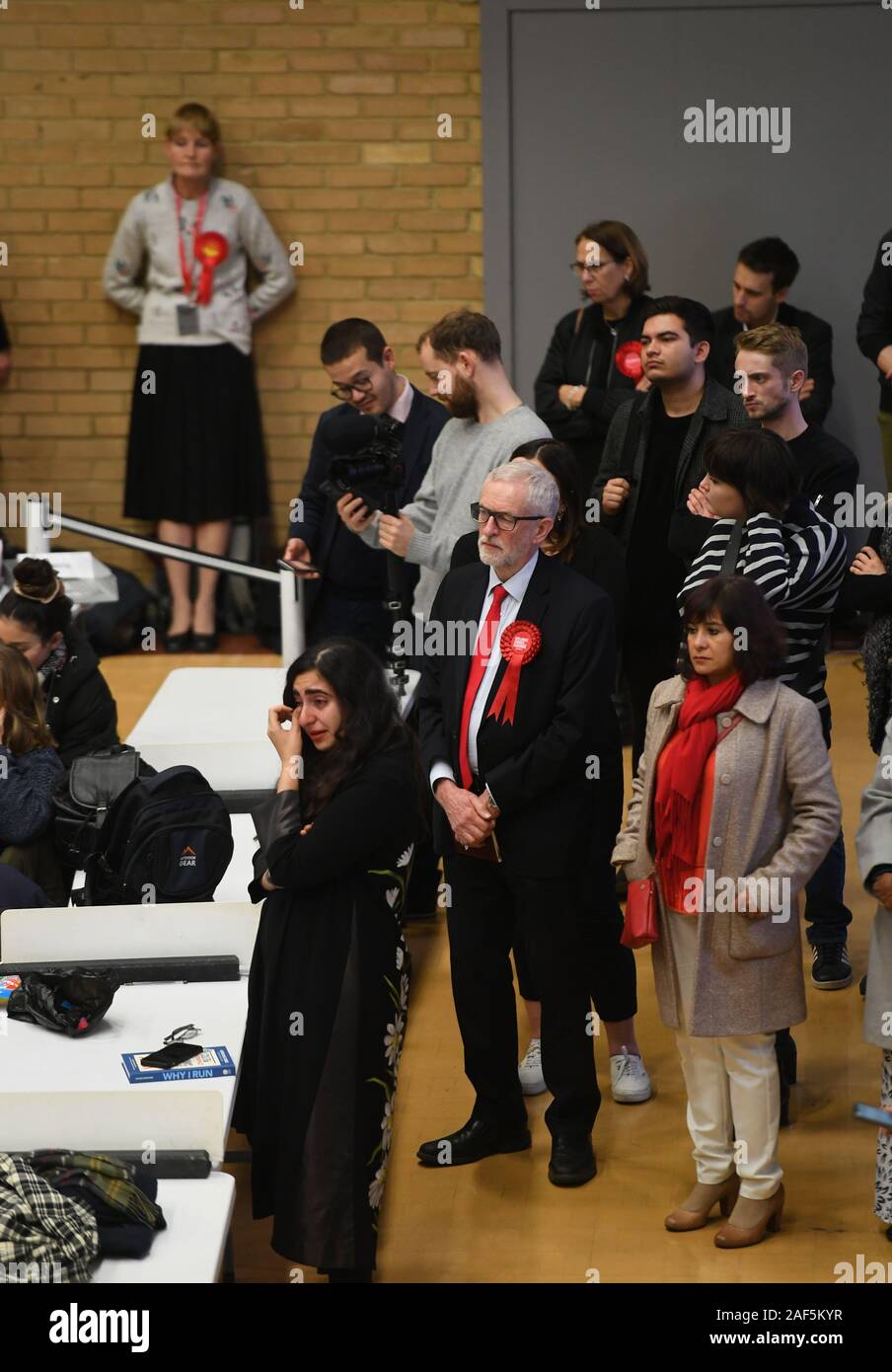 A woman appears emotional in front of Labour leader Jeremy Corbyn, with ...