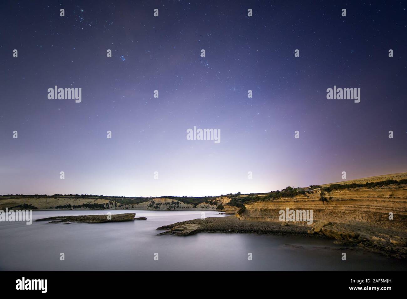 A clear winter sky over Delimara Bay in the South of Malta Stock Photo ...