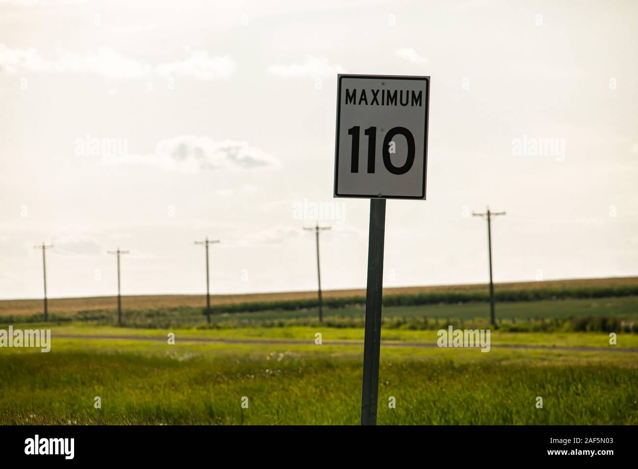 Selective focus view of 110 maximum speed limit sign on the roadside ...