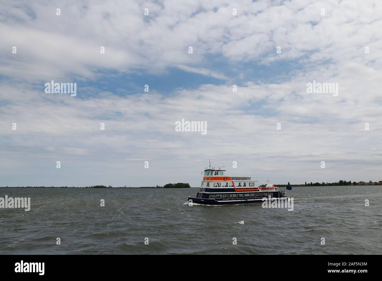 Volendam, Netherlands - May 16, 2019: A ferry on the sea in cloudy day ...