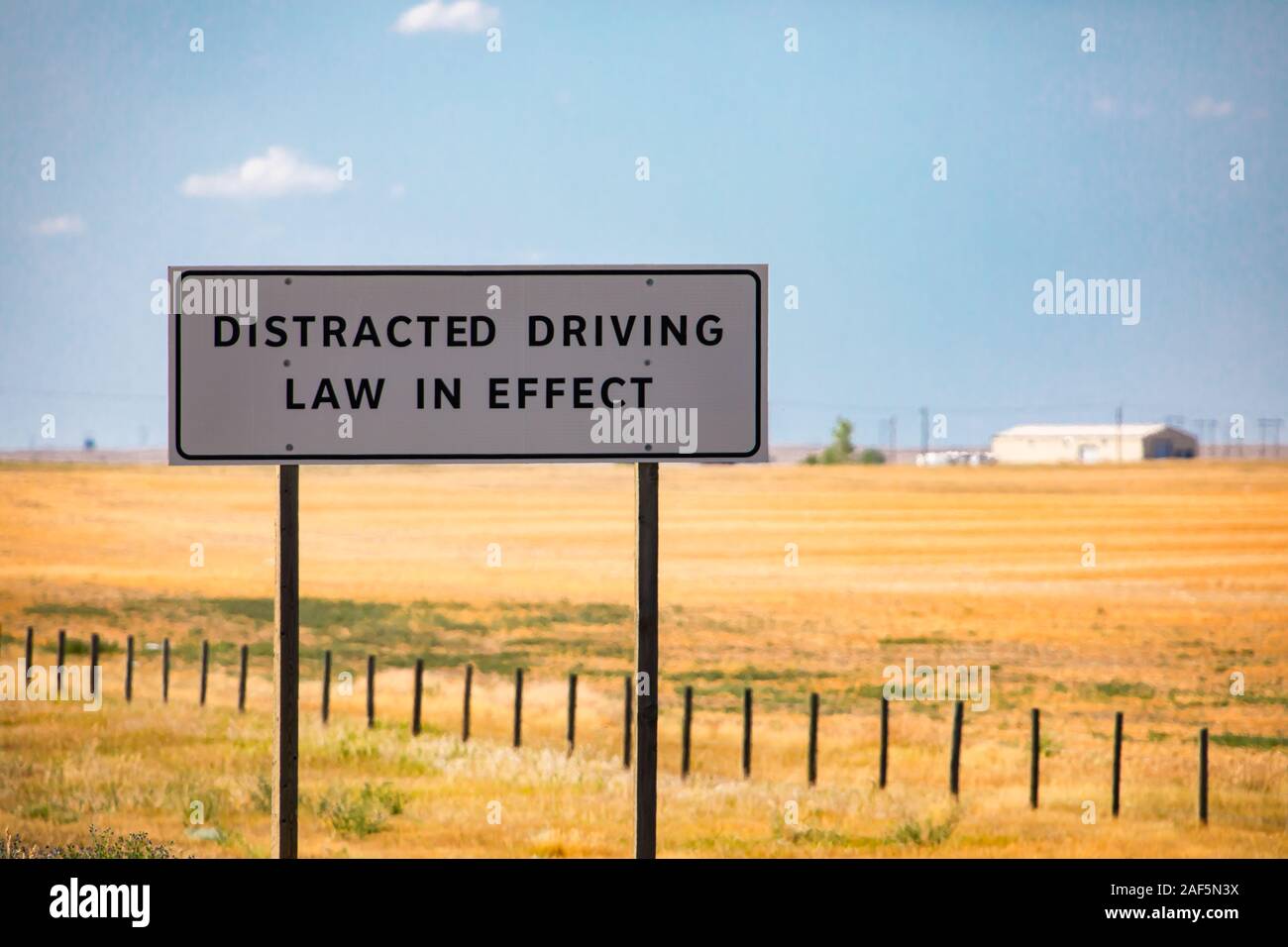 Information Road white Sign, Distracted driving law in effect., on ...