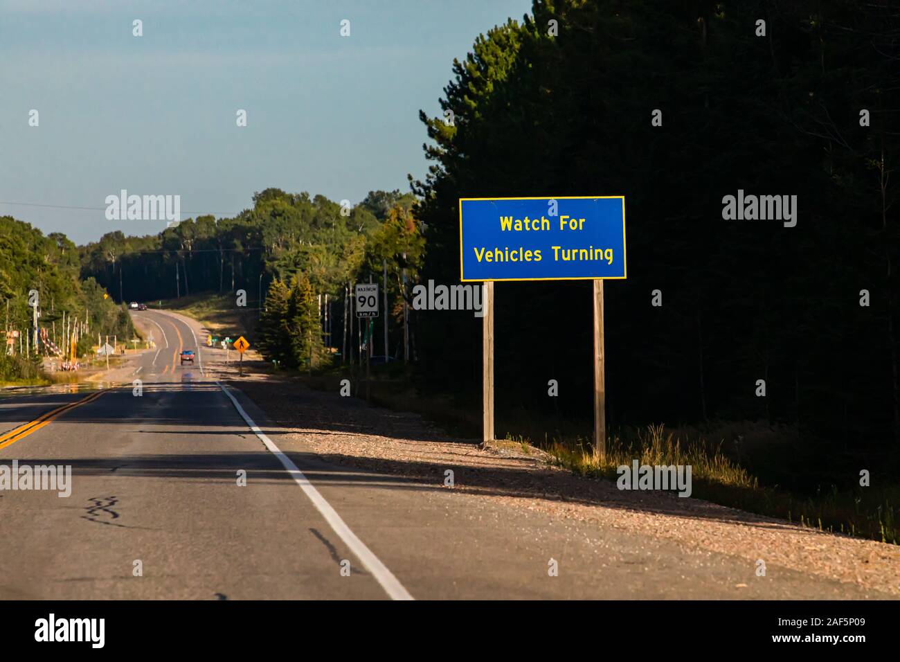 Blue Information Road Sign with yellow writing, watch for vehicles ...