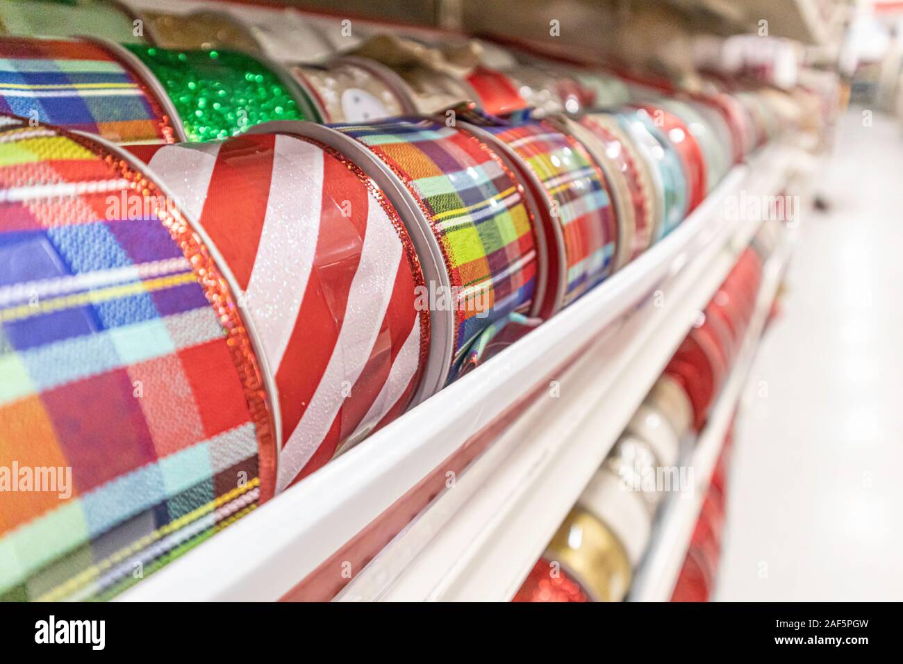 Christmas ribbons on display for sale in retail store Stock Photo - Alamy