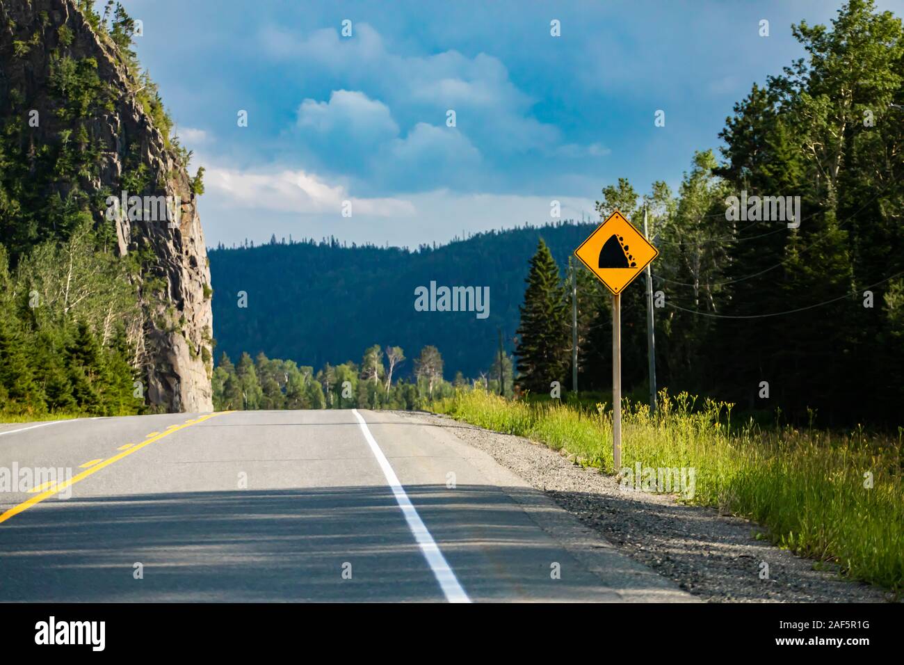 watch for fallen rock and be prepared to avoid a collision sign. with a ...