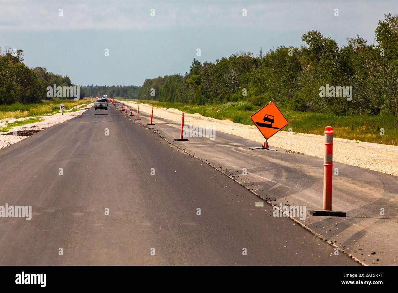 road under construction with new asphalt, Temporary condition signs ...