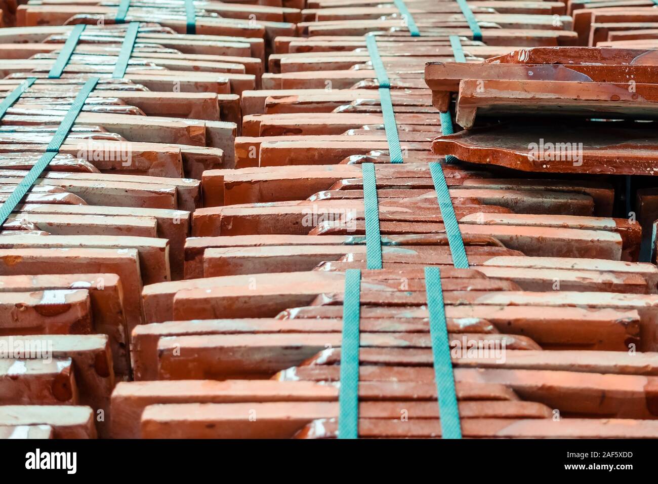 Close up to many pile of roof tiles traditional clay stack for a ...
