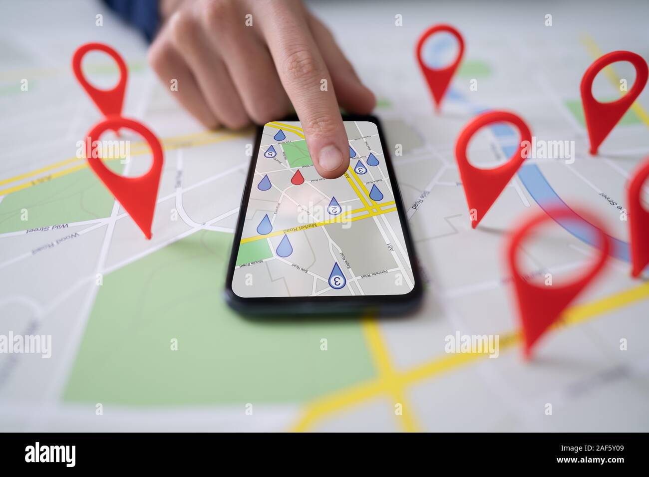 Person Using Map With Red Location Markers On Mobile Phone Stock Photo ...