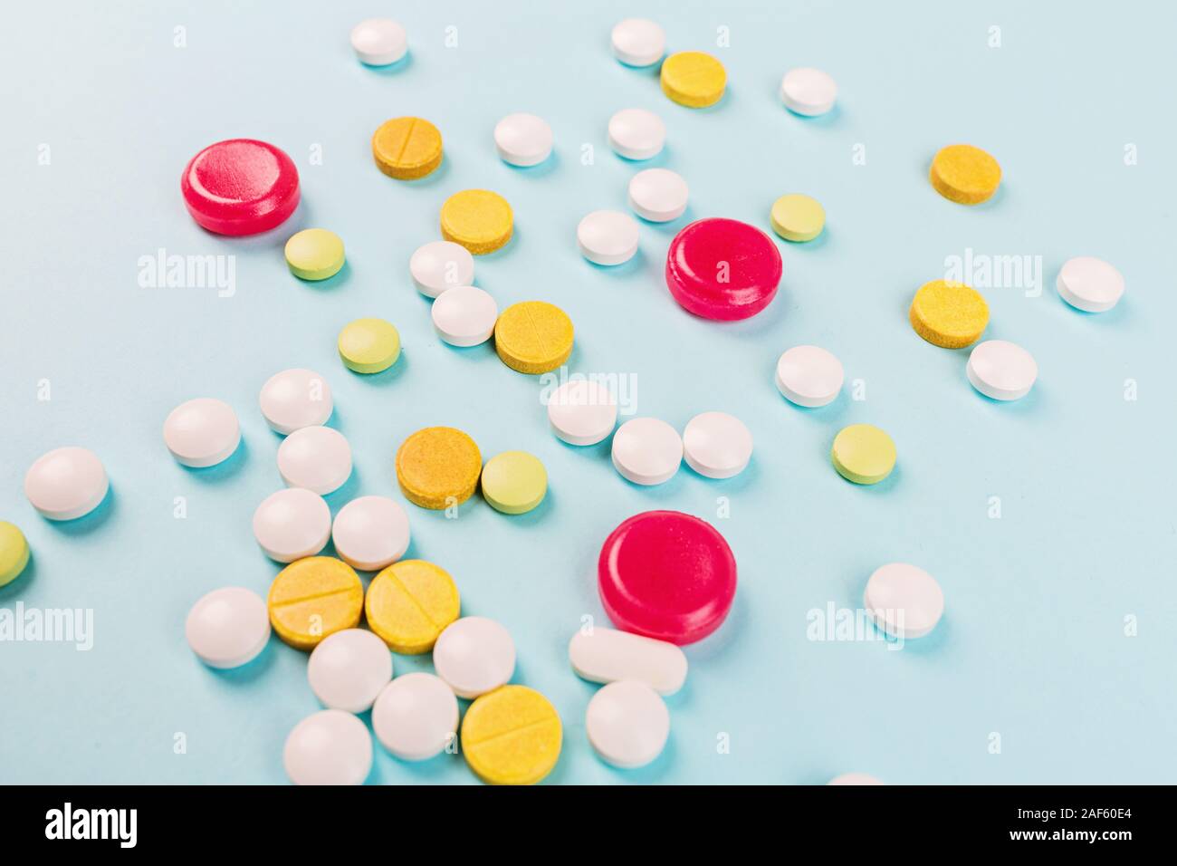 Colorful pills on a pastel blue background. Flat lay, top view ...