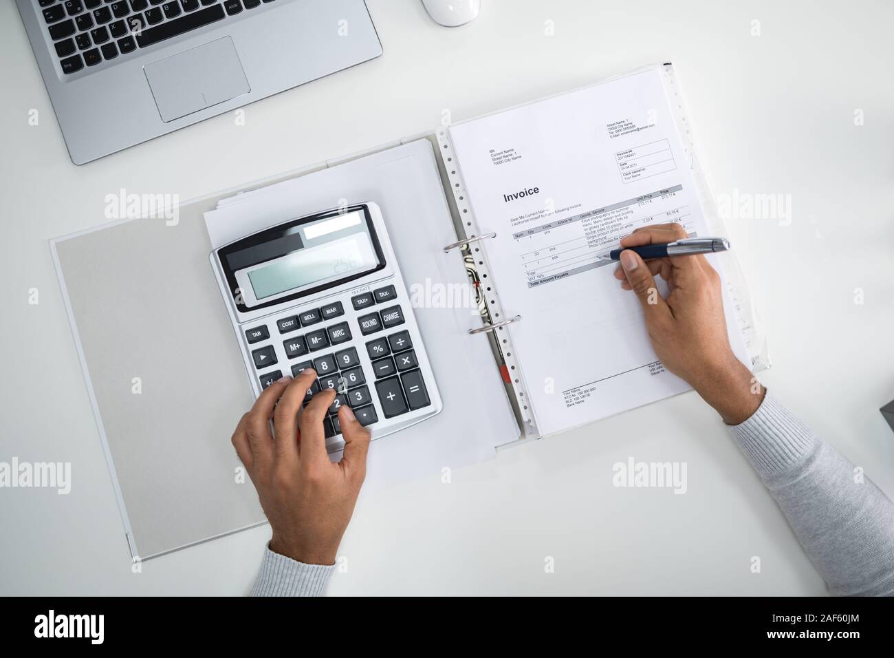 High Angle View Of Accountant Writing On Documents At Desk In Office ...