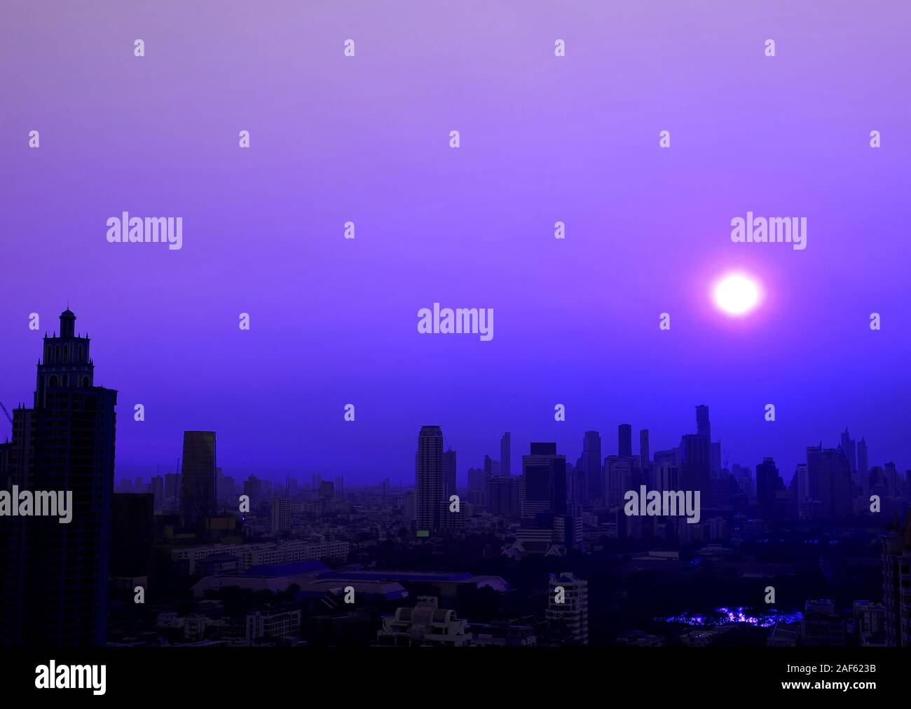 Pop art style dazzling sun setting over the city in vivid purple color ...