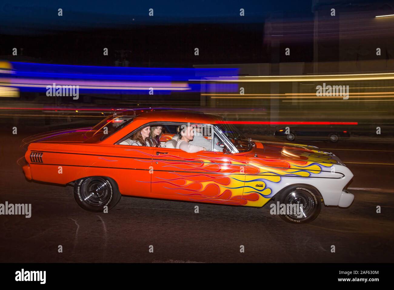 A restored and modified 1964 Ford Falcon coupe cruising in the Moab ...