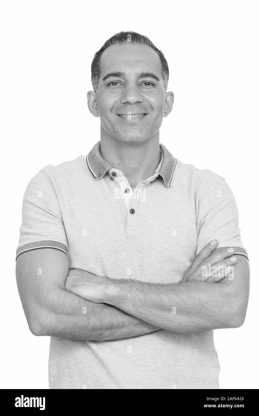 Mature happy Persian man smiling with arms crossed Stock Photo - Alamy