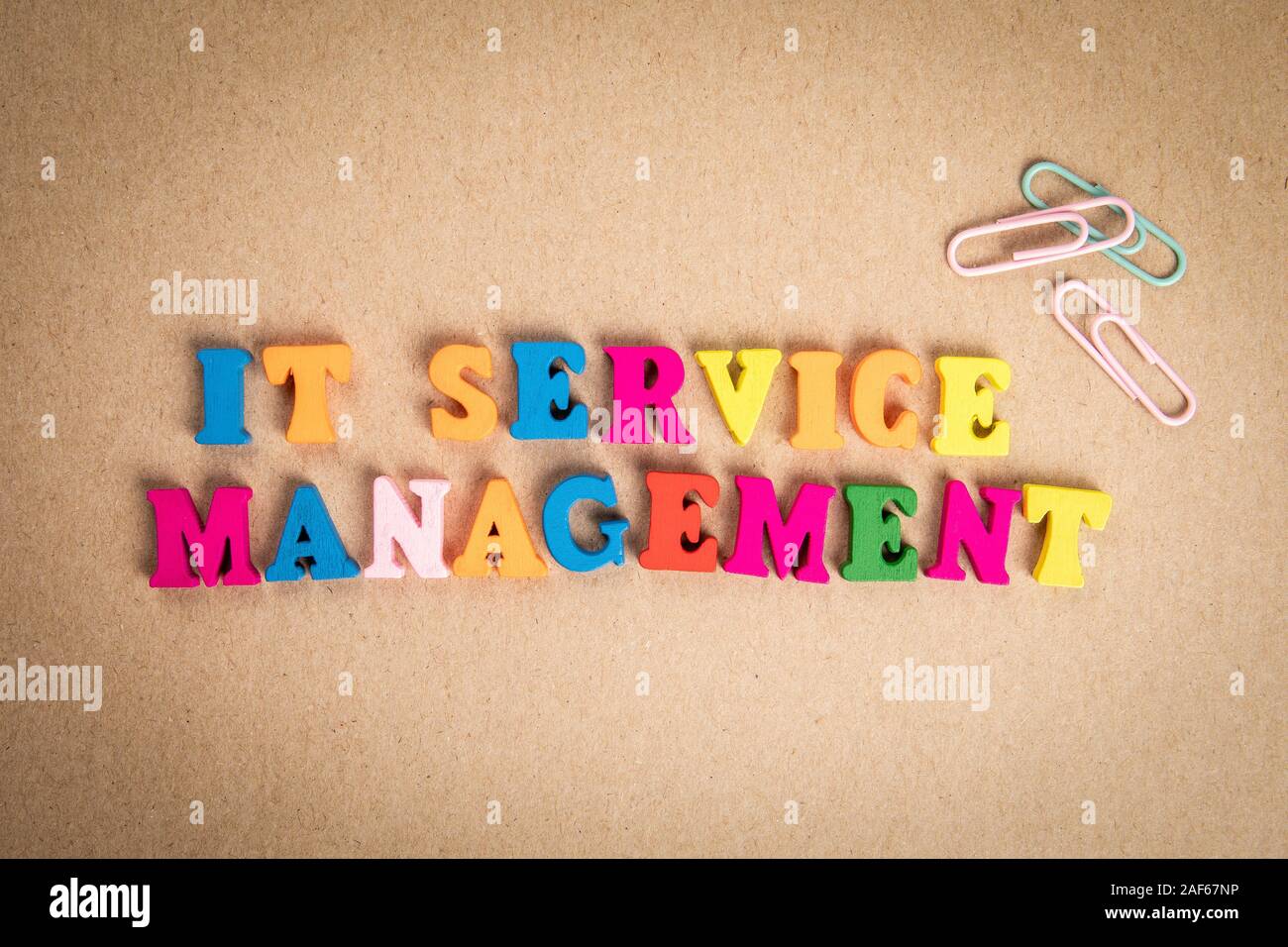 It Service Management. Text from colorful wooden letters on cardboard ...