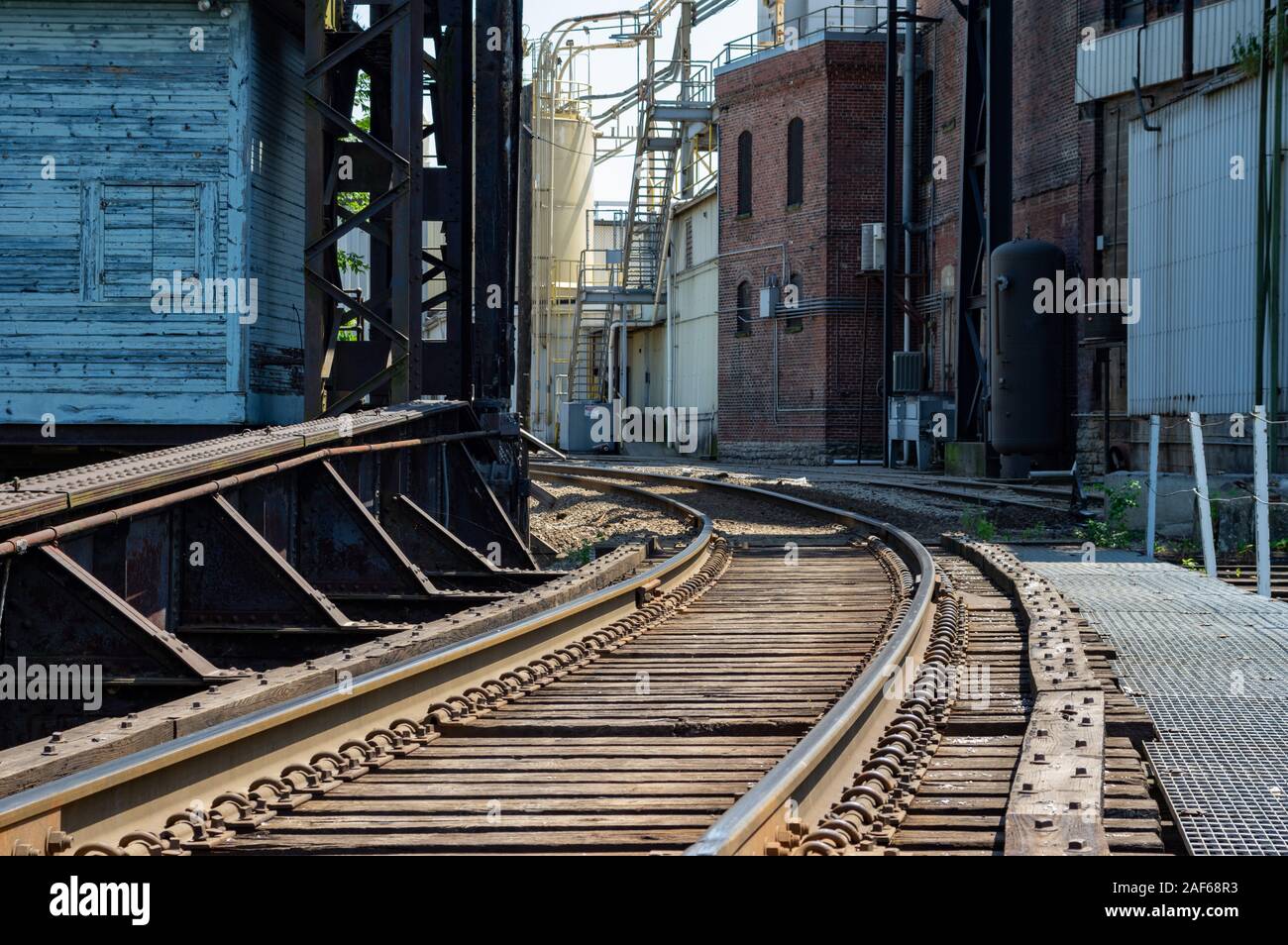 A railroad running on the backside of some warehouse buildings Stock ...