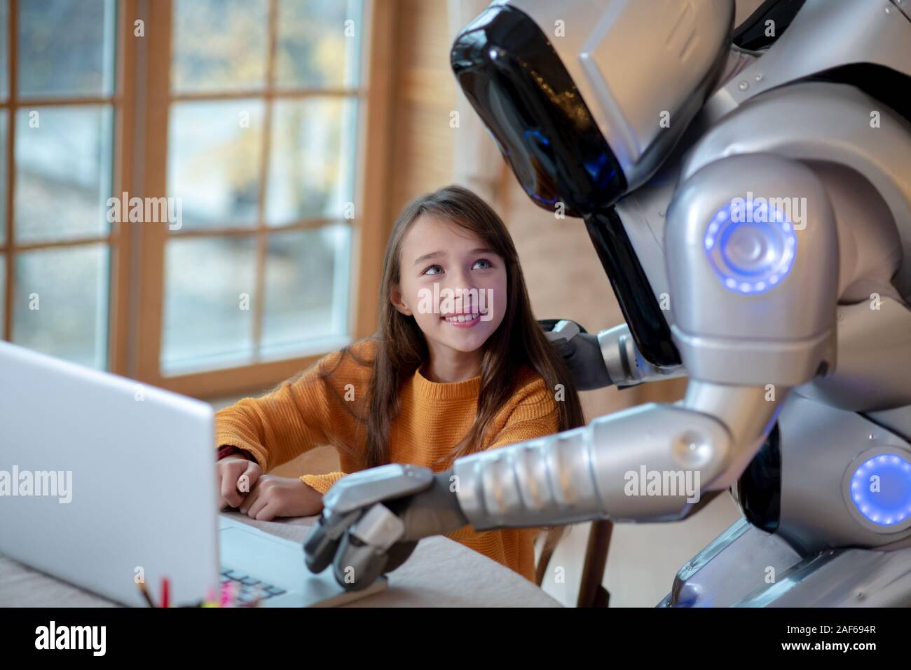 Robot helping a girl with her homework Stock Photo - Alamy