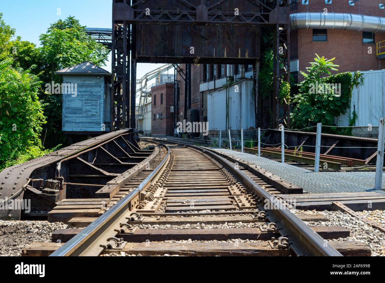A railroad running on the backside of some warehouse buildings Stock ...