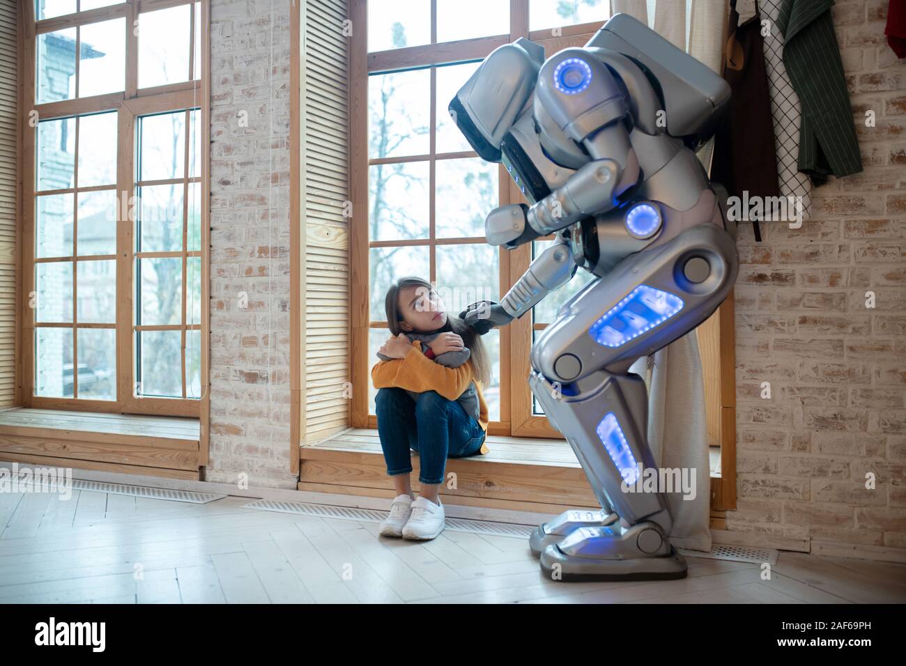 Big house robot touching girls shoulder tenderly Stock Photo - Alamy