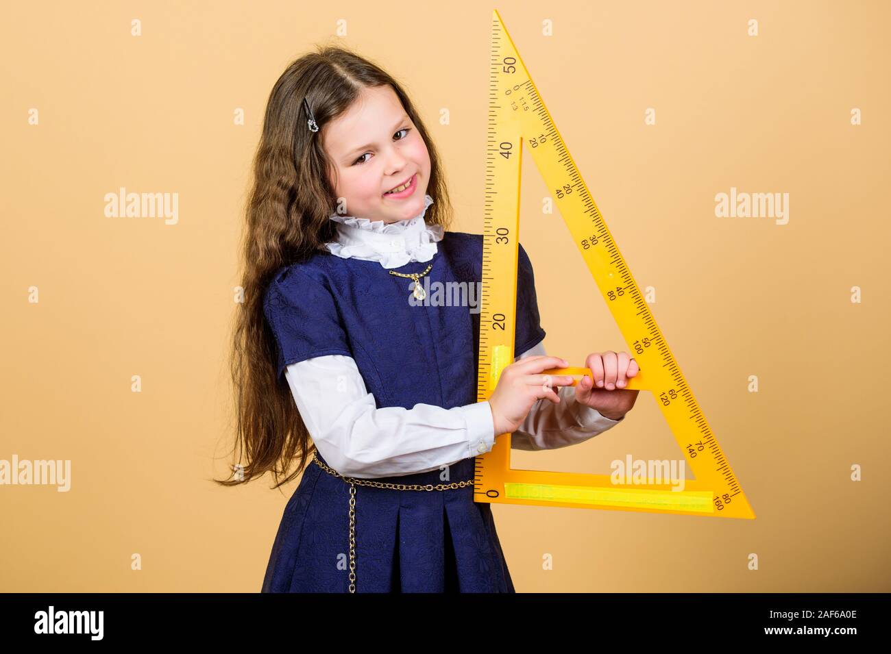 STEM school disciplines. Pupil girl with big ruler. small girl back to ...