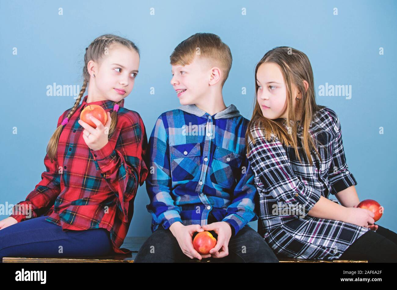 School snack concept. Group cheerful teenagers communicating and eating ...