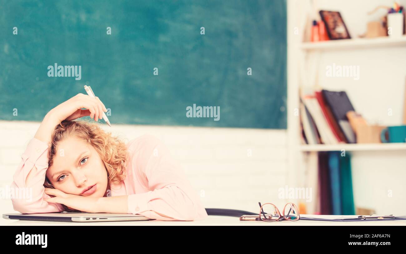 Woman tired in school classroom. Teacher exhausted after hard working ...
