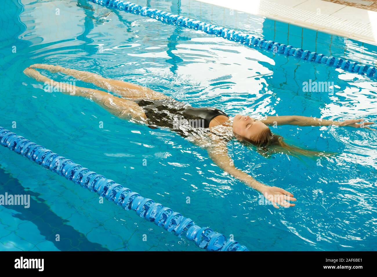 Woman swimming on the back in pool Stock Photo - Alamy