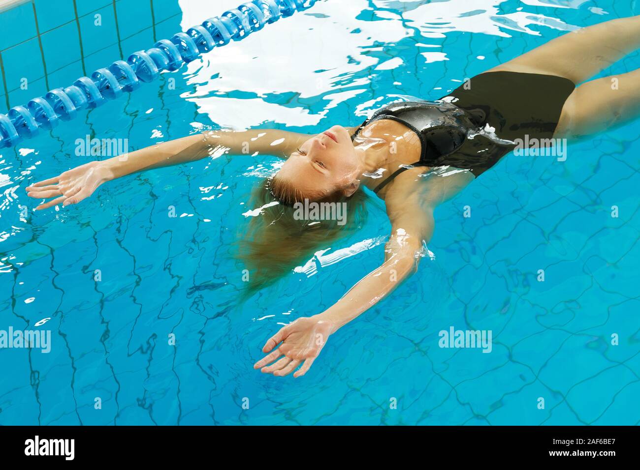 Woman swimming on the back in pool Stock Photo - Alamy