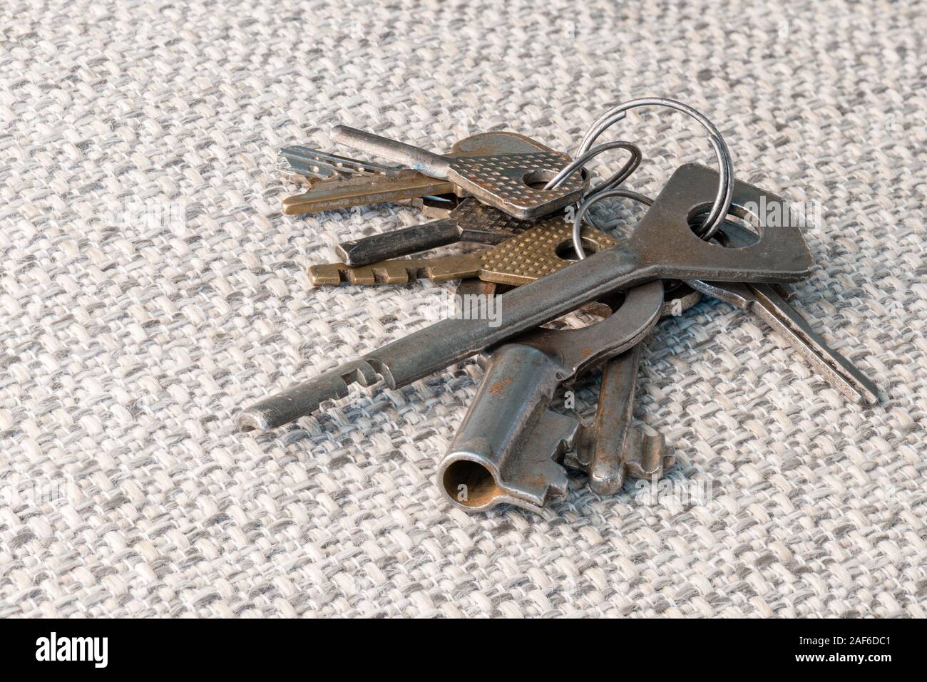 Bunch of several metal keys on fabric closeup Stock Photo - Alamy