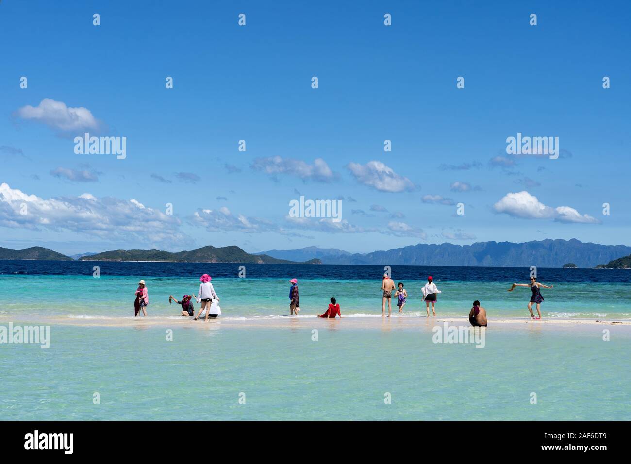 A group of Korean tourists enjoying their time on the sandbar of ...