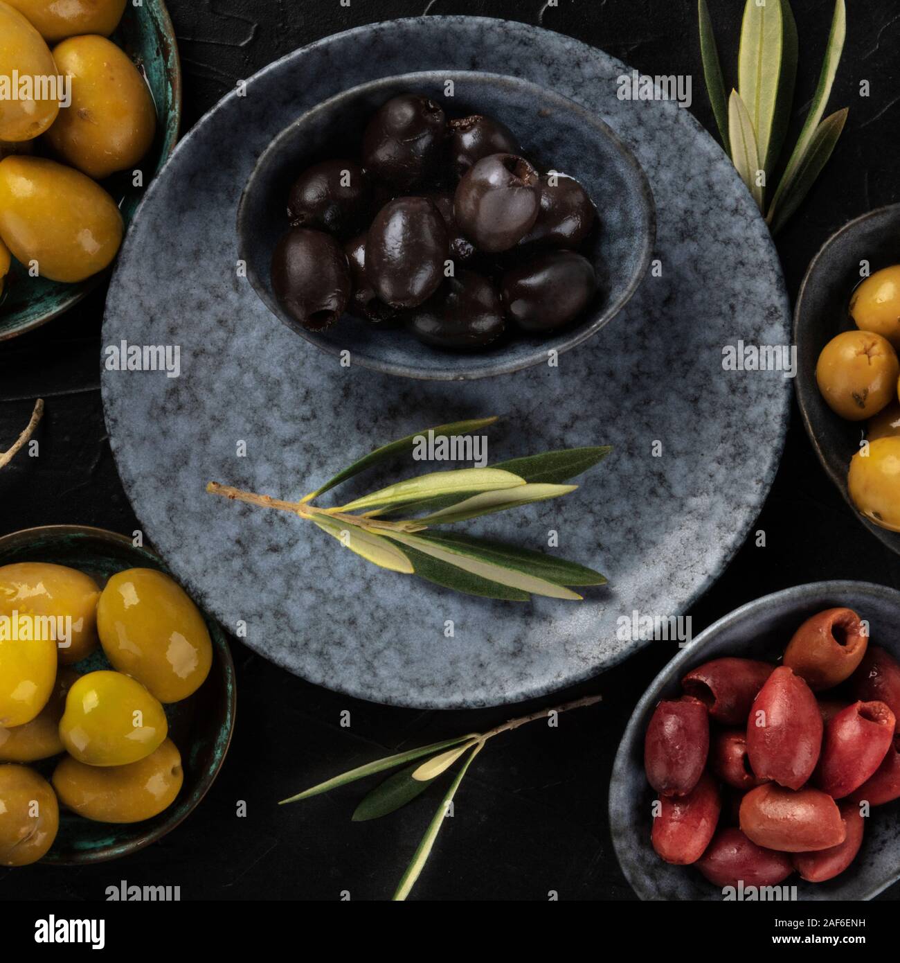 Olives, an overhead square shot. Black, green and brown olives, shot ...