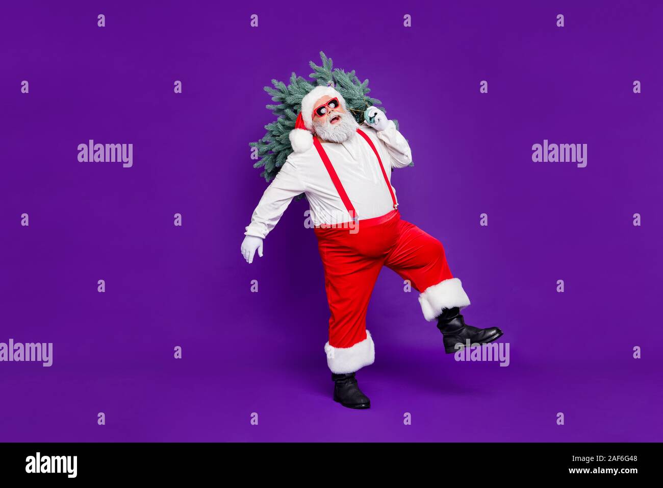 Let it snow. Full length photo of funny fat santa father holding x-mas ...