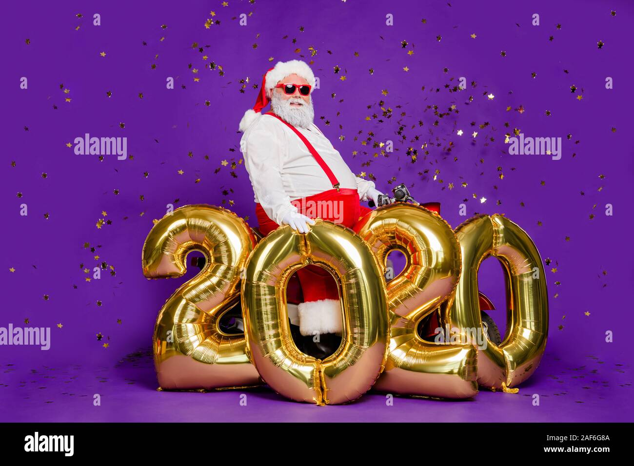 Ho-ho-ho. Full body photo of fat santa man sitting on motorbike holding ...