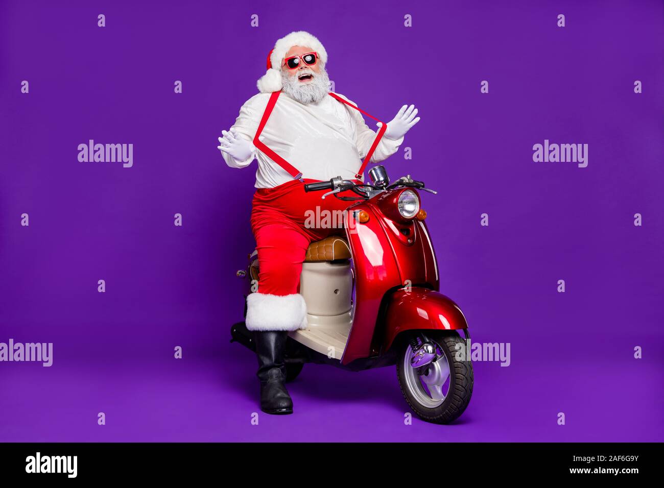 Photo of grey hair santa claus man came newyear theme party by bike ...