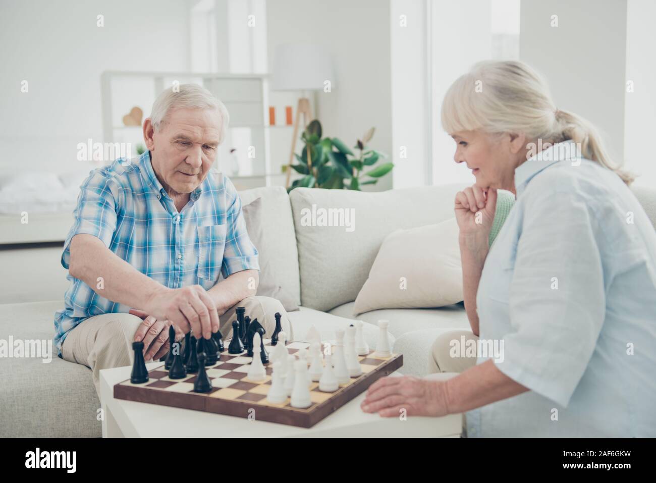 Woman playing chess indoors grey hi-res stock photography and images ...
